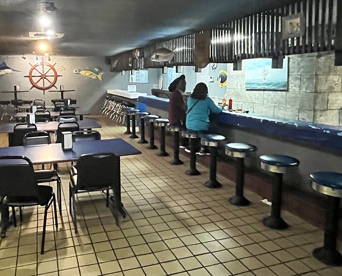 The oyster bar in action—where strangers become friends united by the universal language of "pass the hot sauce" and "aren't these amazing?"