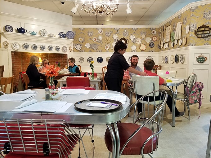 The cafe in action – where vintage-loving diners gather among decorative plates and warm brick to refuel for the next round of treasure hunting.