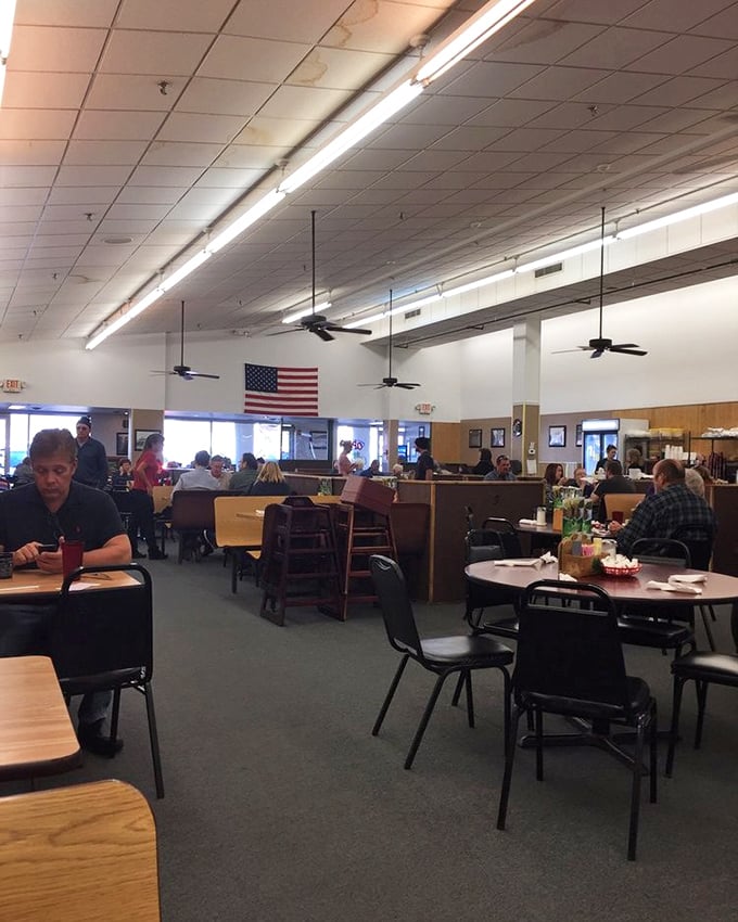 A dining room where strangers become neighbors over plates of comfort food. Under that American flag, breakfast democracy is alive and well.