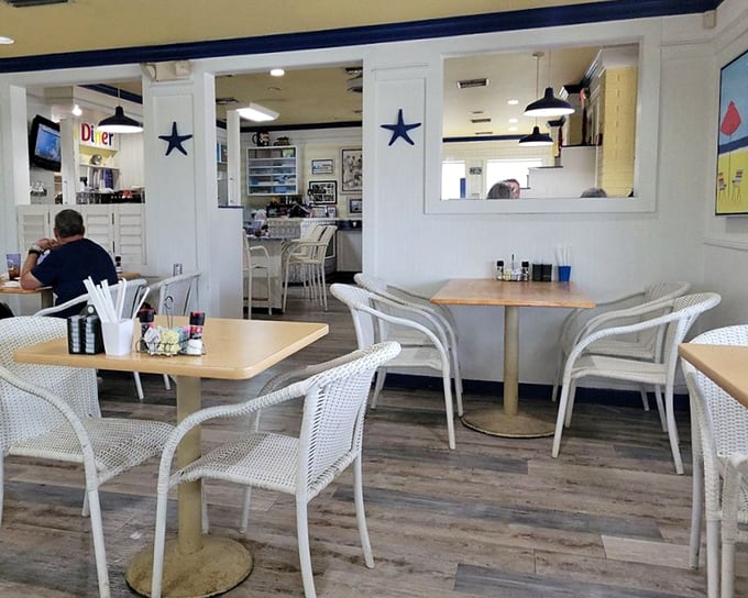 White chairs, blue accents, and the promise of coffee refills. This dining room isn't just a space—it's the stage where breakfast dreams come true.