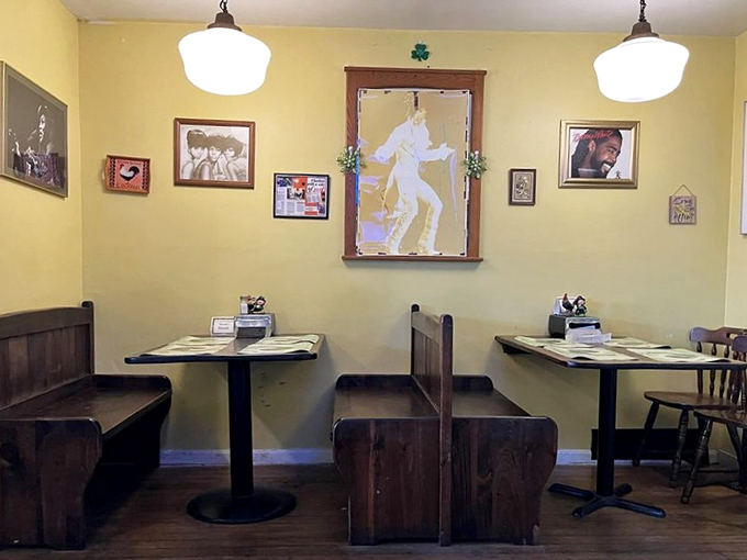 Church pew booths and simple tables create a dining room that feels like Sunday dinner at grandma's—if grandma were a fried chicken virtuoso.