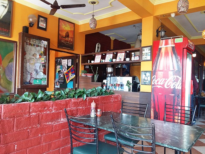 Bright yellow walls and pendant lighting create a cheerful vibe that's as warm and inviting as the food itself.