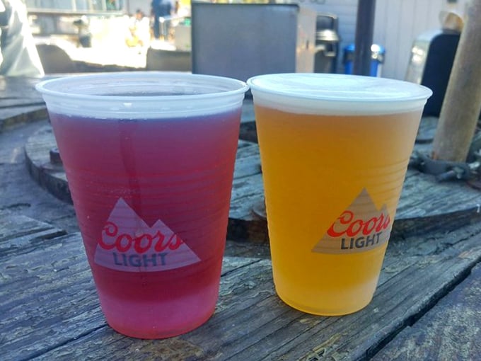 Cold beers on a weathered harbor table—proof that sometimes the simplest pleasures are the ones worth driving hours for.
