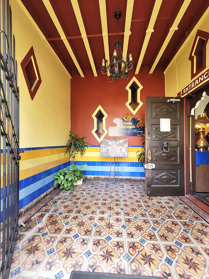 The entrance beckons with its vibrant tiles and geometric doorway—like a portal to another world that happens to be ADA-compliant.