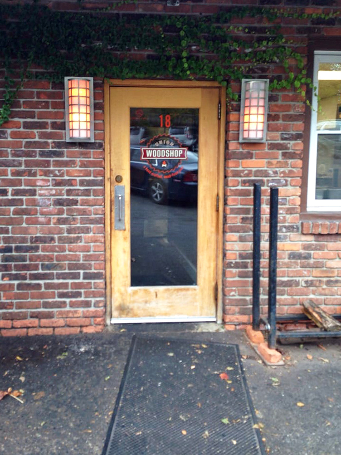 The wooden door with its simple Woodshop logo—Michigan's equivalent of finding the wardrobe to Narnia, but with more brisket.