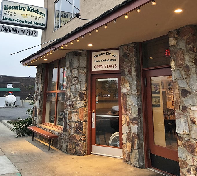 String lights and stone walls create the kind of entrance that says, "Come on in, stranger—but you won't leave as one."