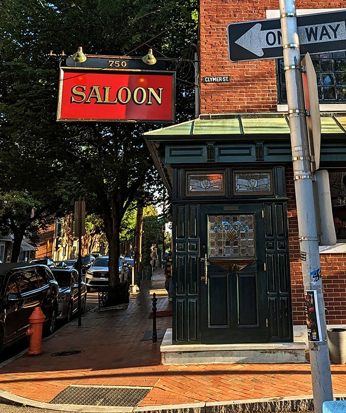 The iconic red Saloon sign hanging above the entrance—a beacon of culinary promise that's guided hungry Philadelphians for generations.