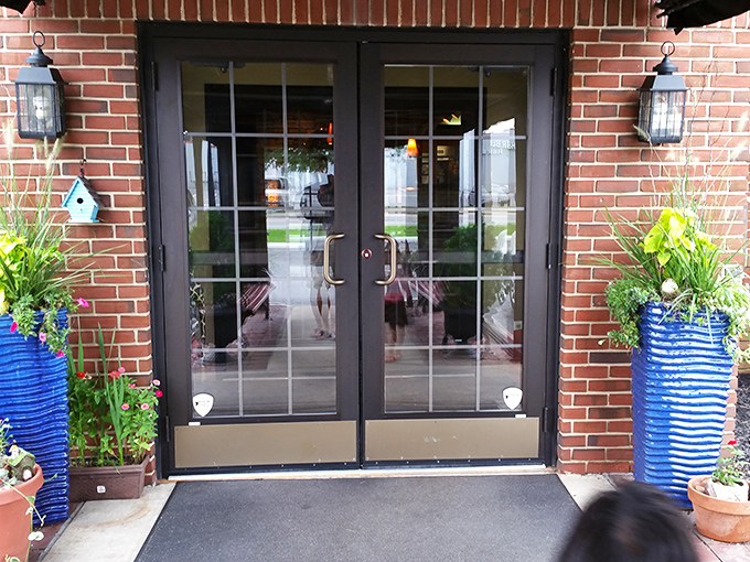 The entrance says, "Come on in, we've been expecting you." Those blue planters add a pop of color that hints at the creativity waiting inside.