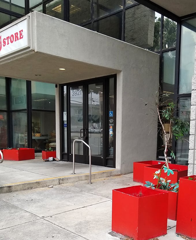 The entrance's red planters add a pop of color to the concrete exterior – a cheerful welcome to bargain hunters and donation-droppers alike.