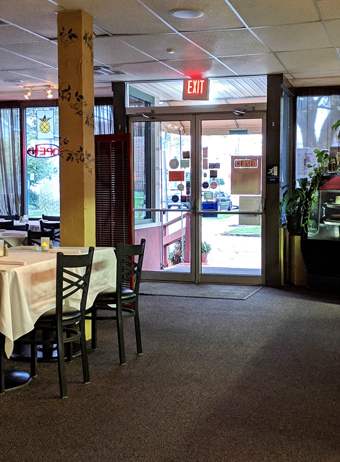 Sunlight streams through the entrance, illuminating a space that feels both welcoming and special. The perfect transition from everyday life to dining adventure.