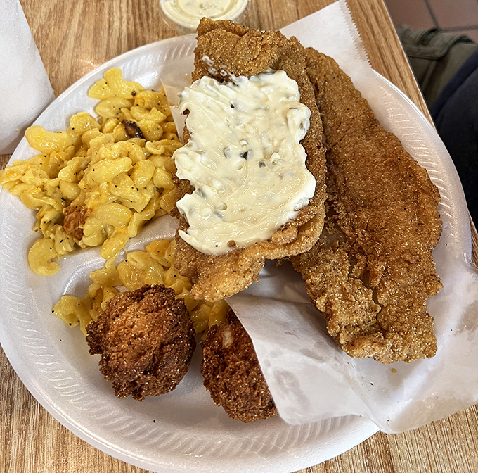Southern comfort on a plate: crispy fish, creamy mac and cheese, and a cornbread that would make grandmothers nod in approval.