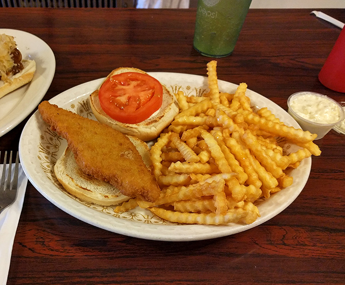 A golden-fried fish sandwich with crinkle-cut fries – proof that simplicity, when done right, outshines complexity every single time.