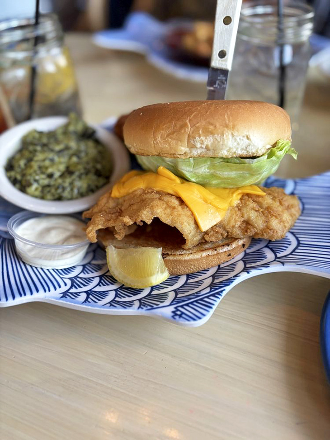 This fish sandwich isn't just lunch—it's architecture. Crispy fish, melty cheese, and fresh lettuce stacked with the precision of a delicious Jenga tower.