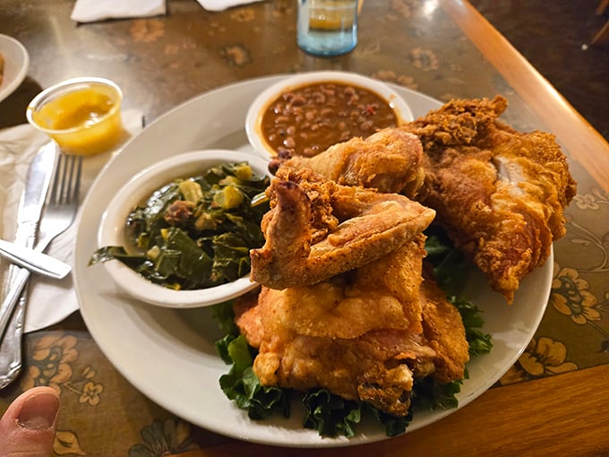 Southern-fried chicken with collard greens and beans—proof that heaven exists and it's made of perfectly seasoned, crispy-skinned poultry.