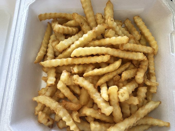 Crinkle-cut fries that achieve the perfect balance—crispy exterior, fluffy interior, and just enough salt to make you reach for "just one more."