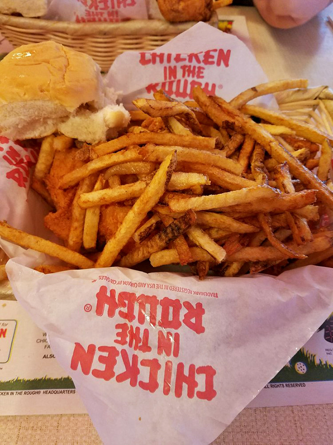 These aren't just fries—they're crispy potato masterpieces served in their natural habitat: red and white checkered paper that signals deliciousness ahead. 