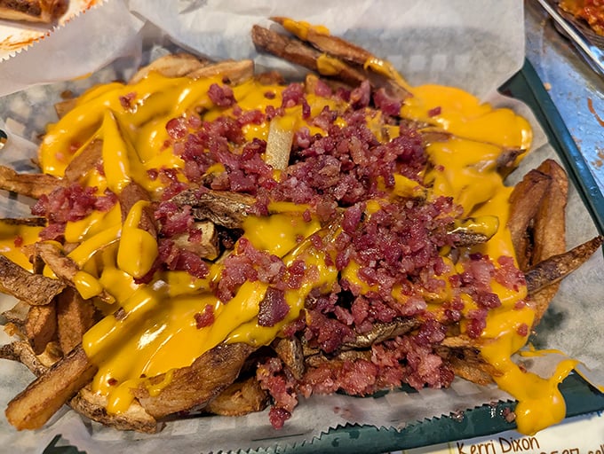 These aren't just any fries—they're the canvas for a masterpiece of melted cheese and bacon that makes diet plans surrender immediately.