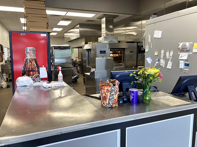 Behind the scenes where pizza magic happens – stainless steel, precision, and the kind of organized chaos that produces perfection.