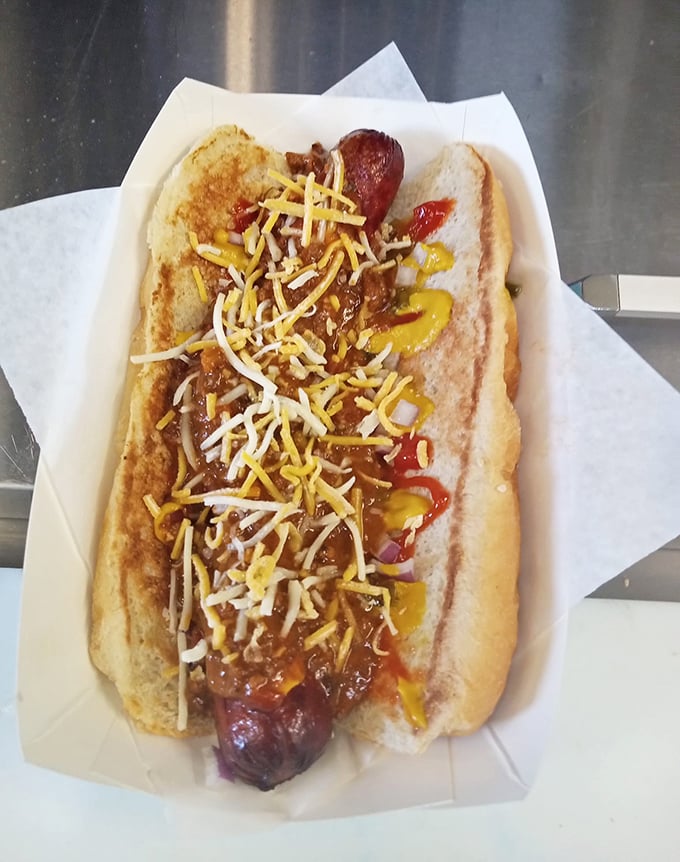The hot dog—dressed to impress with chili, cheese, and condiments in a harmonious arrangement that makes every bite a flavor party.