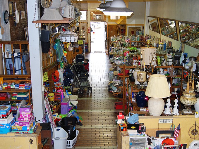 Narrow pathways between treasures create a maze of possibility—turn one corner and find toys, another reveals vintage lamps.