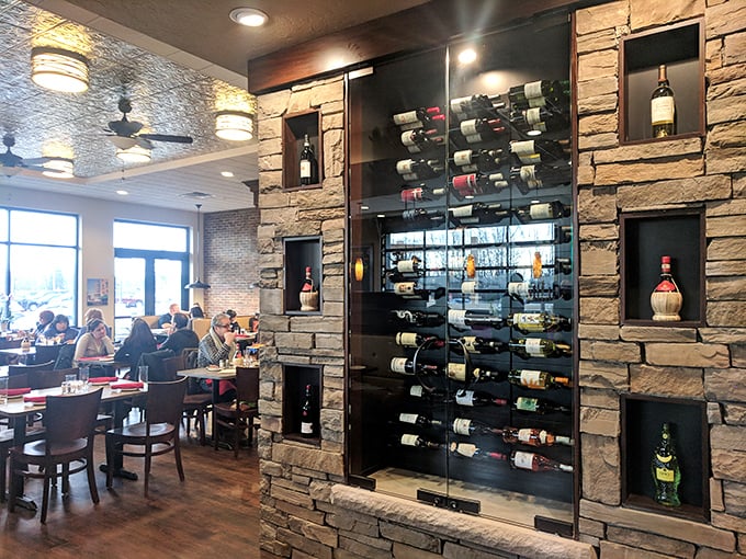 The stone-and-wood wine display isn't just storage—it's a gallery exhibition of potential happiness, bottled and waiting for your table.