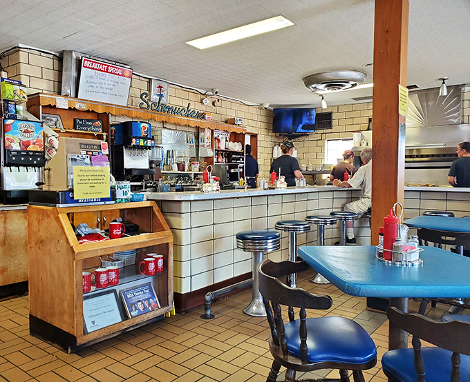 The counter view reveals the heart of operations – where coffee is poured, orders are called, and regulars claim their rightful stools.