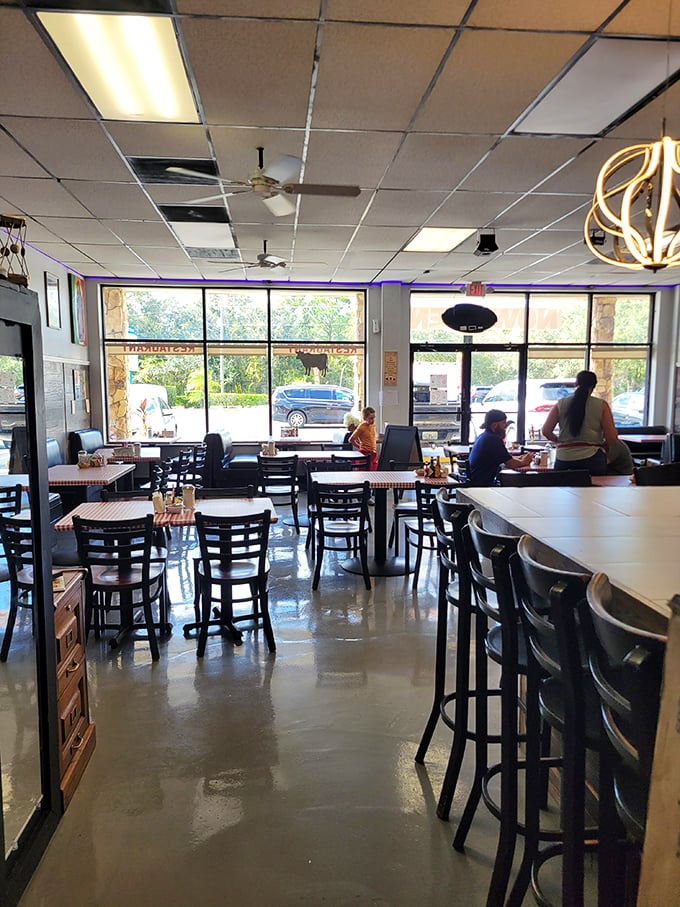 Another angle of JoJo's welcoming interior—where the counter seating lets you watch breakfast magic happen and windows let in that famous Florida sunshine.