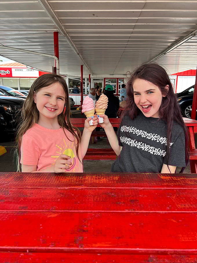 Ice cream cones held high in triumph—the universal symbol of childhood joy that never loses its magic, even as we grow.