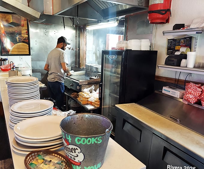 Where the magic happens—a no-nonsense kitchen turning out extraordinary food without fancy gadgets or pretension. Just skill, heart, and a bucket labeled "4 cooks."