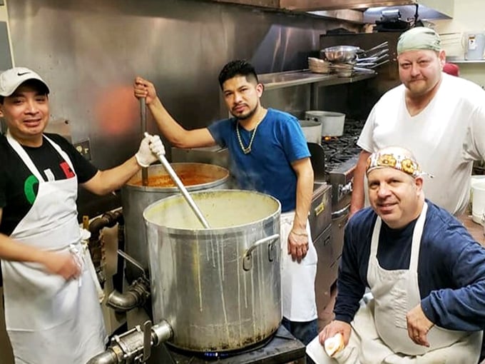 Where the magic happens – the kitchen crew tending to massive pots of sauce that have likely been simmering since before you woke up.