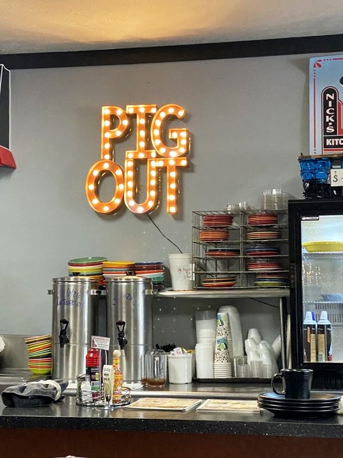 That "PIG OUT" sign isn't just cute decor—it's a mission statement. Behind the counter, Nick's colorful plates wait to carry their precious cargo to hungry patrons.
