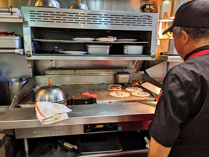 The wizard behind the curtain, flipping pancakes with the confidence that comes from thousands of perfect golden circles.