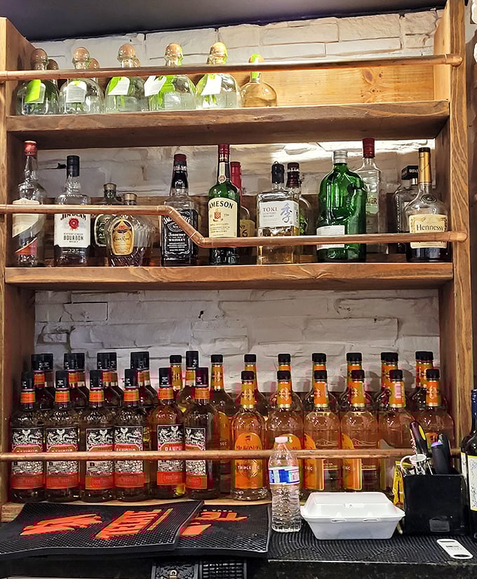 Behind the bar, bottles stand at attention like soldiers ready for cocktail duty. Liquid reinforcements for your dining adventure.