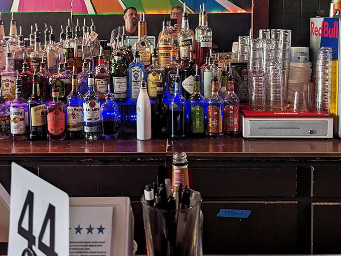 Behind the bar, a rainbow of bottles stands ready for action—like a liquid color wheel of possibilities for your evening's entertainment.
