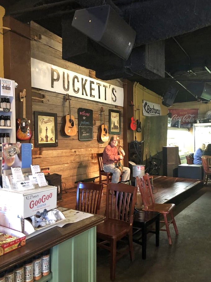 Where music and meals create memories – acoustic guitars hang like promises on wooden walls, waiting for the next performer to soundtrack your dinner.