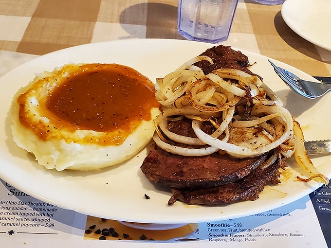 Liver and onions with mashed potatoes—a dish that separates the culinary adventurers from the tourists. That gravy pool deserves its own zip code.