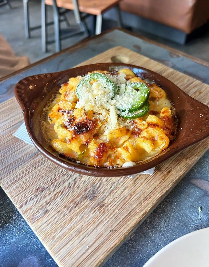 Mac and cheese that bubbles with intention—topped with a jalapeño slice that serves as both warning and invitation.