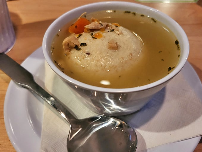 This isn't just soup – it's liquid comfort. The matzo ball floats like a cloud in a broth that grandmothers everywhere would approve of.
