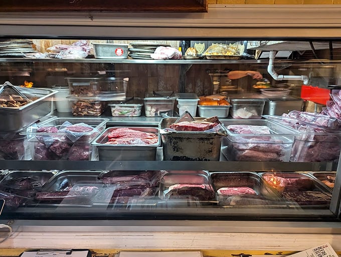 The meat case—a carnivore's jewelry store where marbling isn't a flaw but a feature, and patience becomes the hardest virtue to maintain.