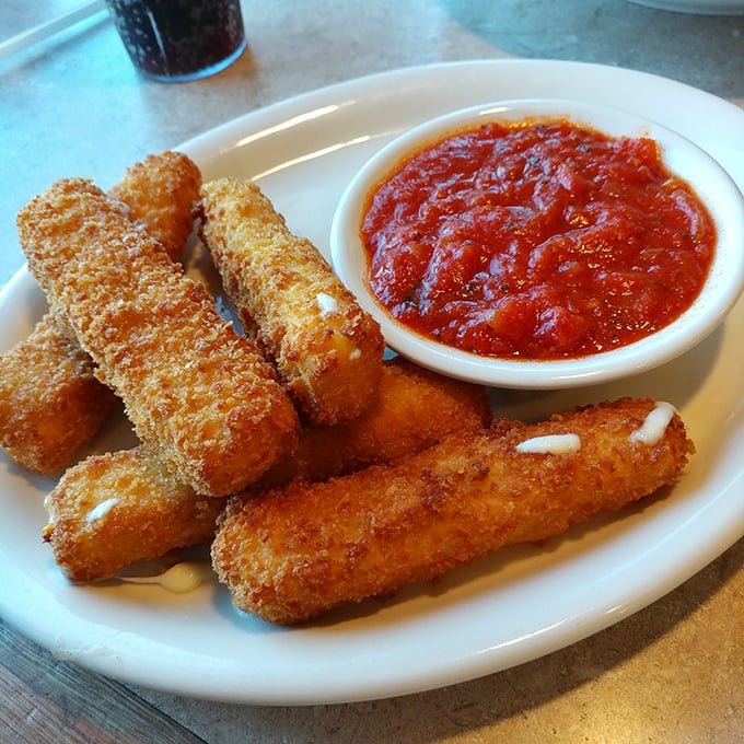 Mozzarella sticks – where the pull of perfectly melted cheese meets the satisfying crunch of golden breading. Marinara stands by, ready for duty.