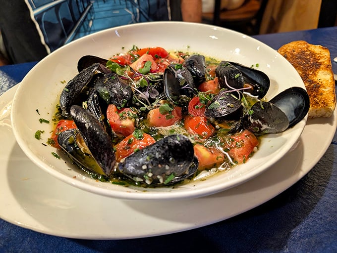 These mussels aren't just served—they're showcased in a fragrant bath of herbs and tomatoes that you'll want to sop up with that toasted bread.