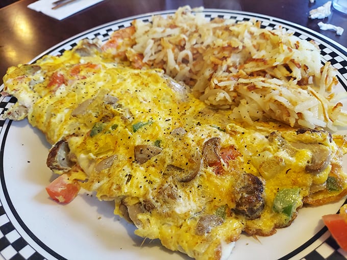 This omelet didn't just incorporate vegetables—it embraced them completely, then cozied up to hash browns that achieved the perfect crisp-to-tender ratio.