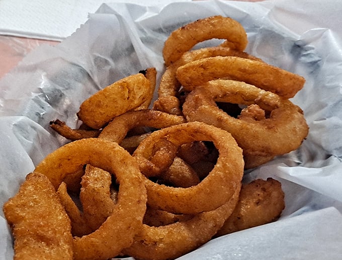 These onion rings deserve their own zip code—perfectly golden hoops of crispy batter surrounding sweet onion that surrenders at first bite.