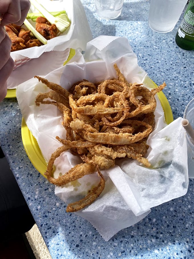 Crispy onion strings piled high like a golden nest – the perfect side dish or, let's be honest, something to snack on while waiting for more seafood.