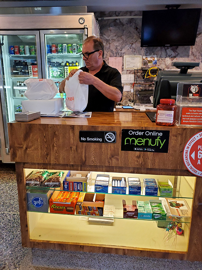 Where takeout dreams begin – the order counter stocked with candy temptations below and efficiency above, staffed by folks who know many customers by name.