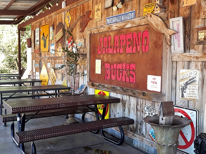 The outdoor dining area feels like your favorite uncle's back porch—if your uncle happened to be a barbecue genius with great taste in vintage signs.