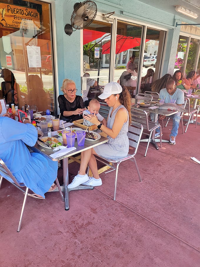 Outdoor seating where families gather, babies included—because good Cuban food is a multi-generational affair.