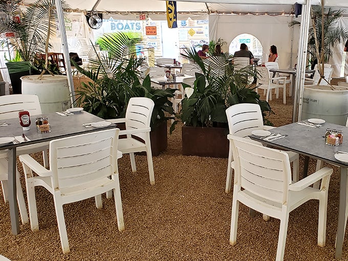 The outdoor dining area offers a breezy escape, where palm fronds and white furniture create a coastal oasis just steps from Annapolis proper.