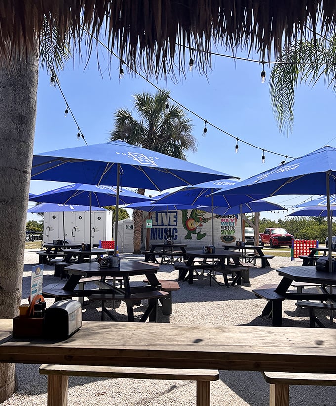 Outdoor seating under blue umbrellas and string lights creates the perfect Florida ambiance—casual, breezy, and ready for memory-making.