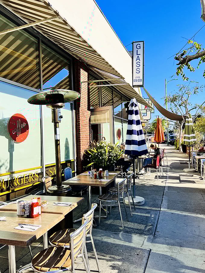 Sidewalk seating that captures LA's perfect weather advantage. Blue umbrellas, sunshine, and breakfast—some combinations simply can't be improved upon.